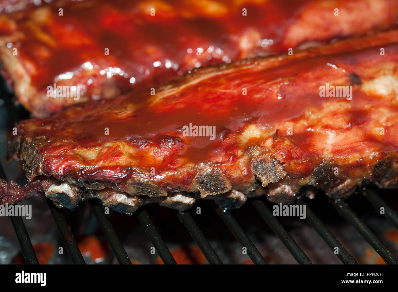 Racks of pork ribs cooking on the bar-b-que Stock Photo - Alamy