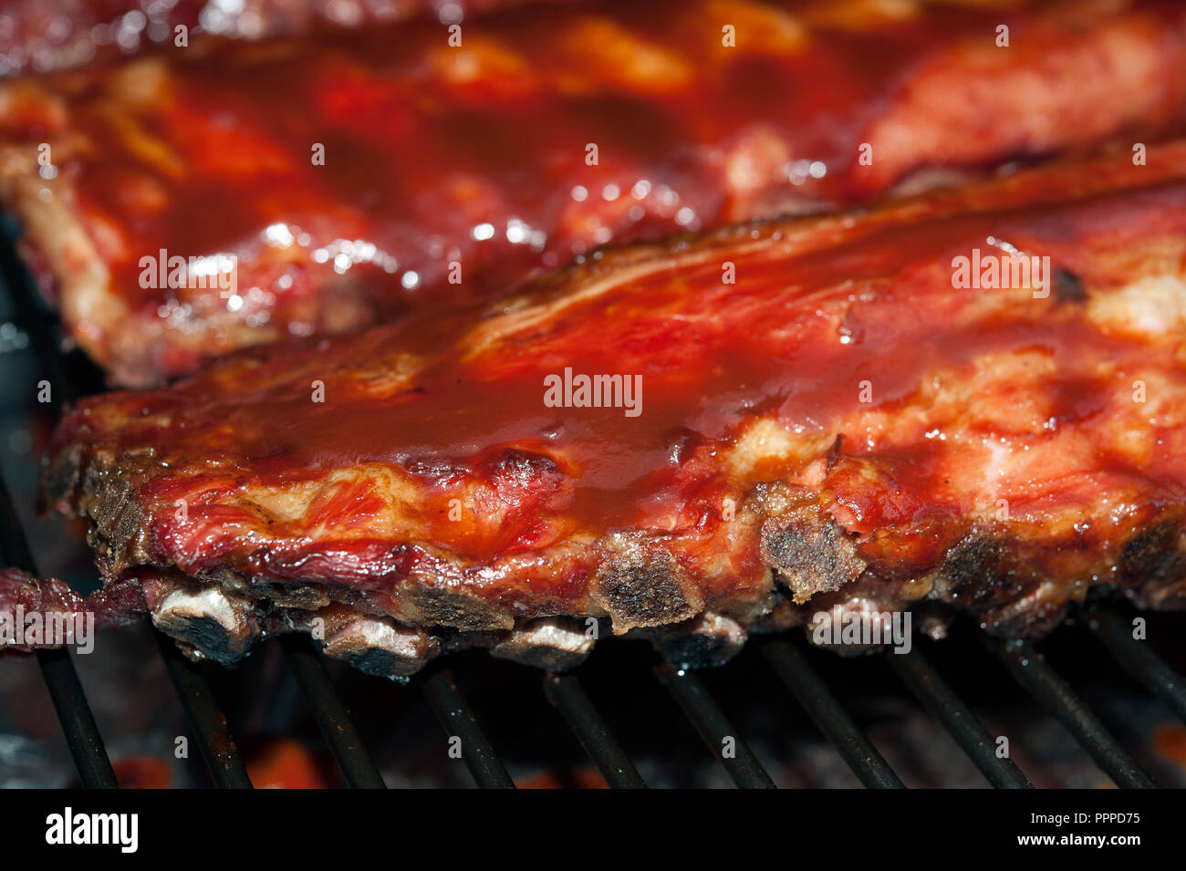 Racks of pork ribs cooking on the bar-b-que Stock Photo - Alamy