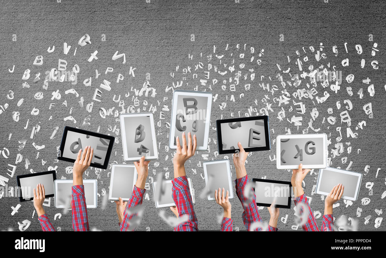 Close of woman hands in line showing tablet pc against concrete wall ...