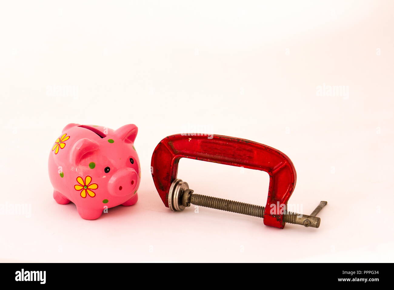 The squeeze on retirement savings for the elderly conceptual image with ...