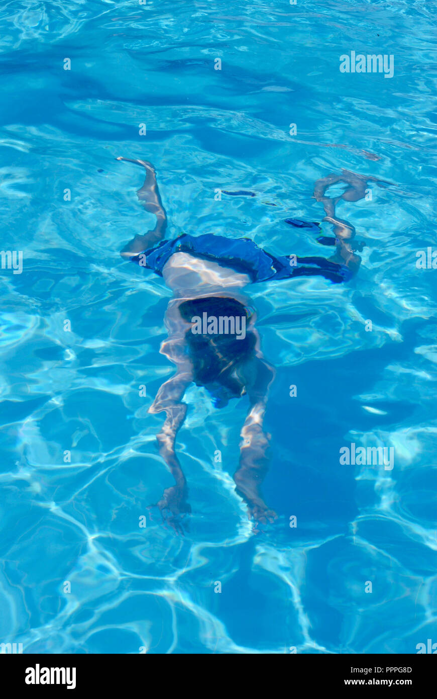 Ten year old boy swimming in a pool Stock Photo - Alamy