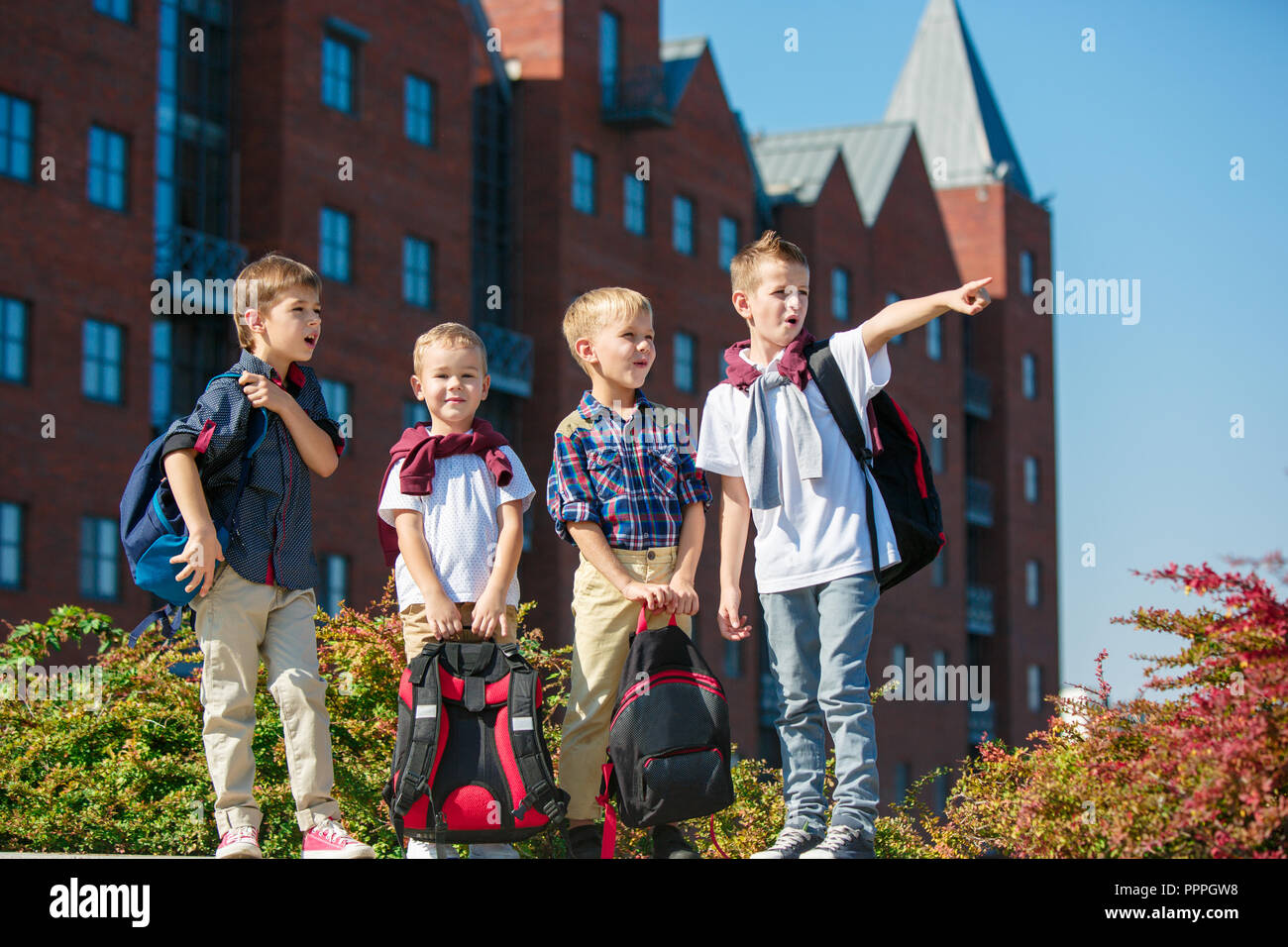 A group of happy smiling children of school and preschool age are ...