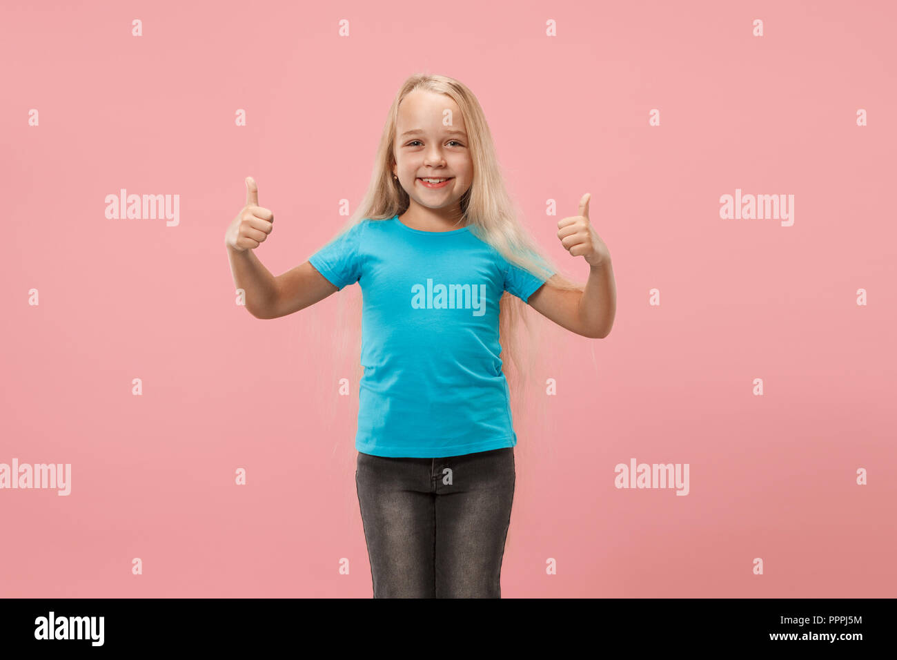 Happy teen girl standing, smiling isolated on trendy pink studio ...