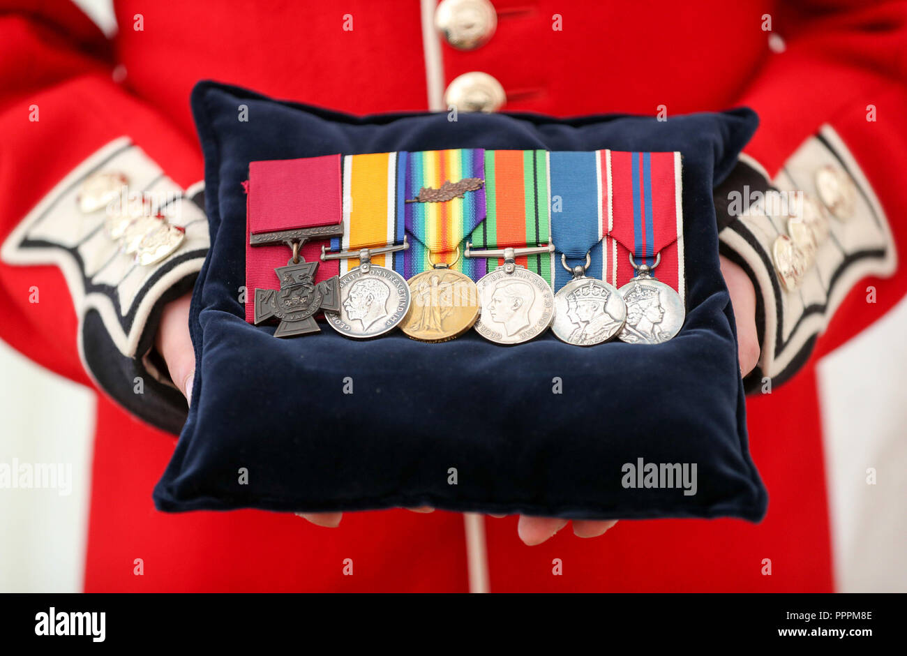 A member of the Coldstream Guards holds the medals of Captain Cyril ...