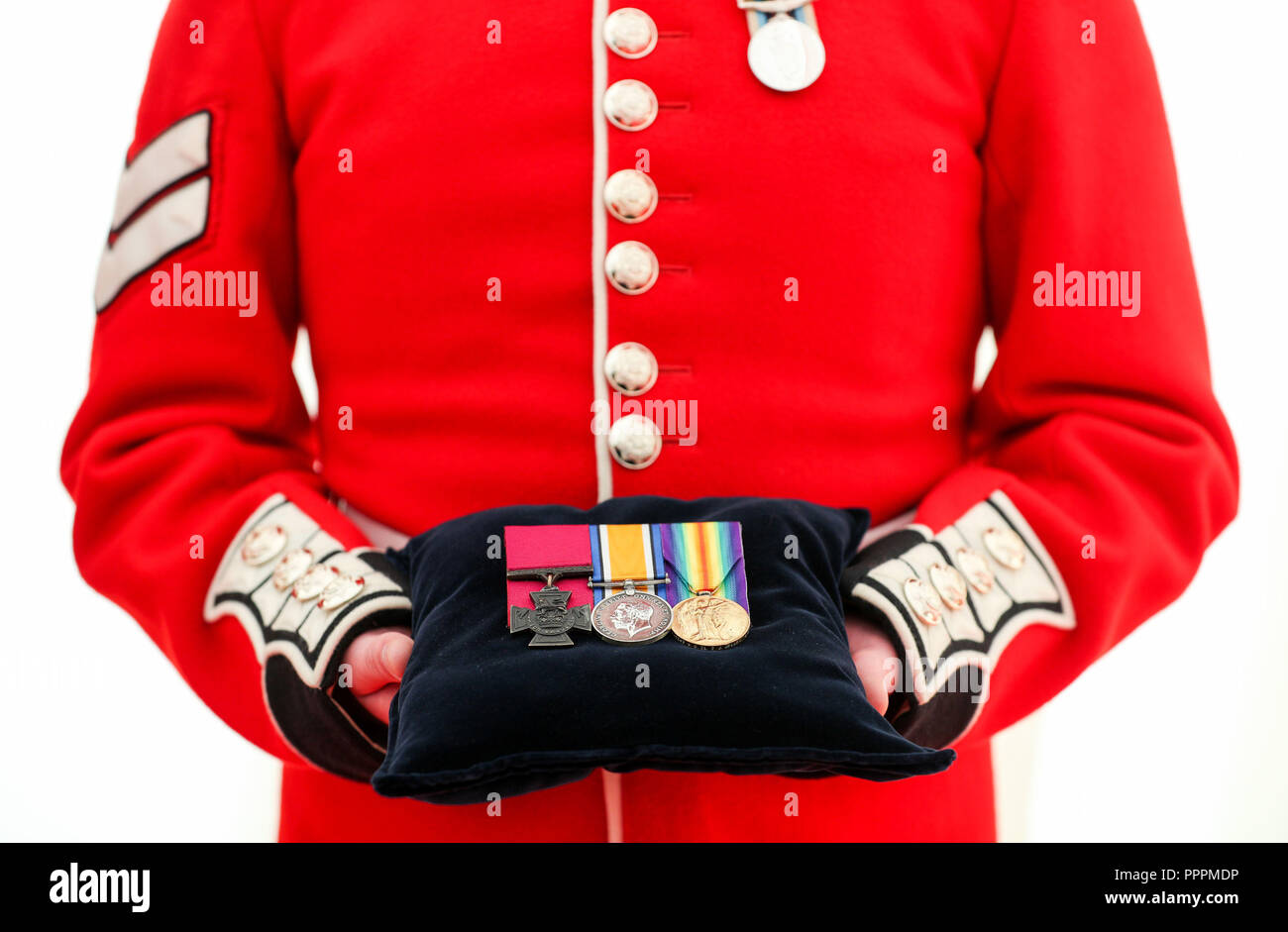 A member of the Coldstream Guards holds the medals of Lance Corporal ...
