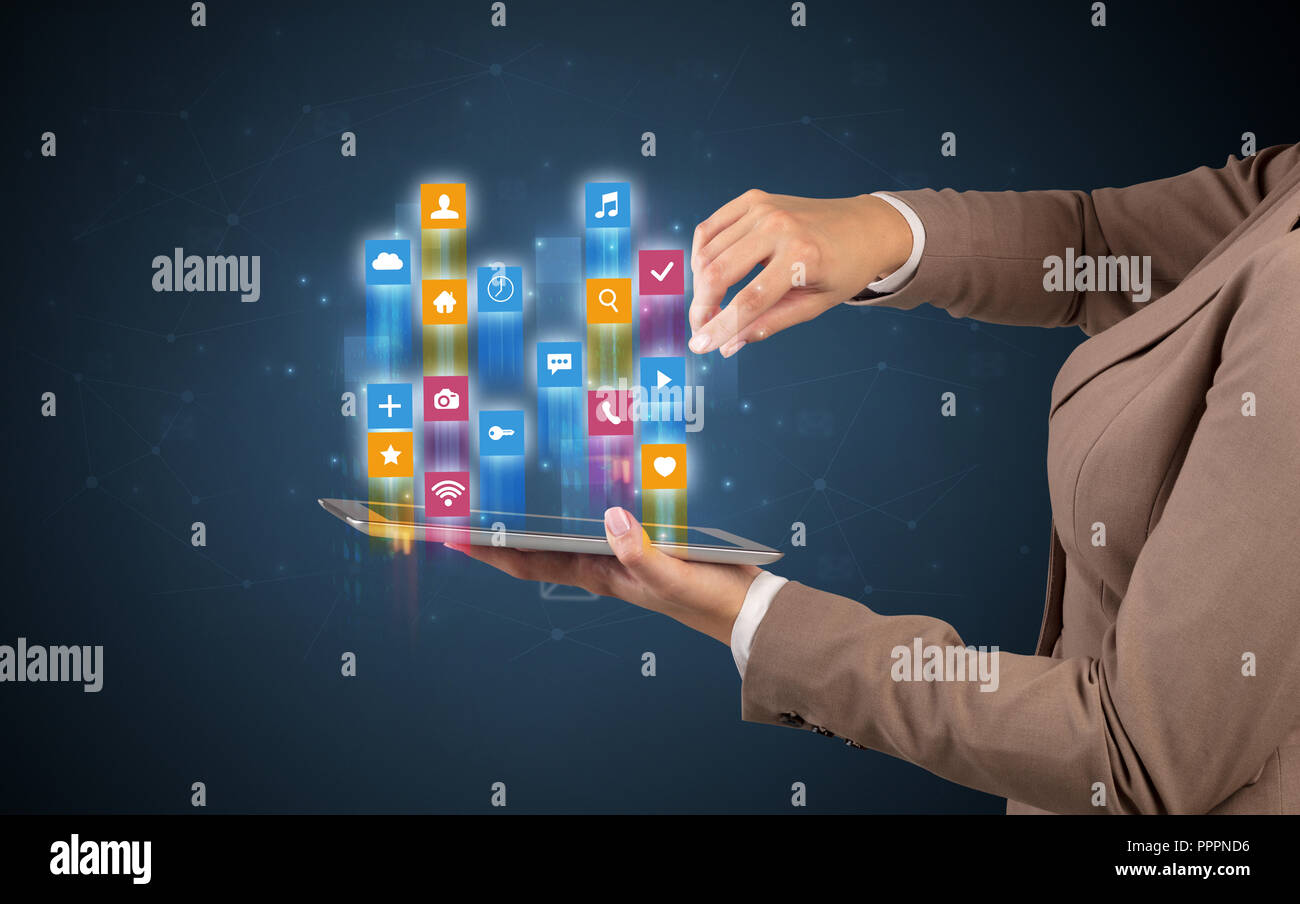 Female elegant hand holding tablet with colourful application icons ...