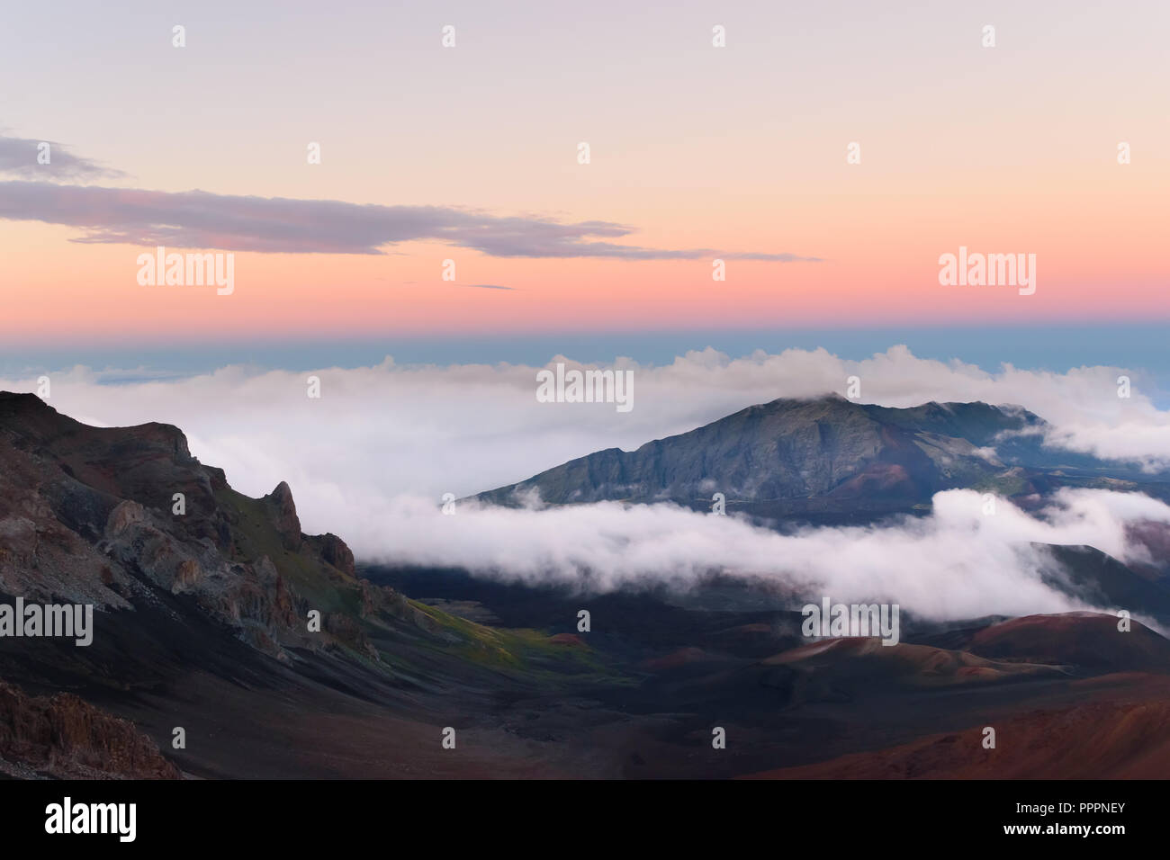 A vibrant pink and blue sunset over the rocky summit of the dormant ...