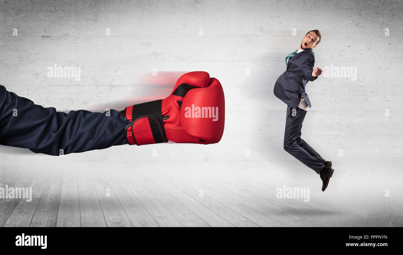 Arm with red boxing gloves hits office worker concept Stock Photo - Alamy
