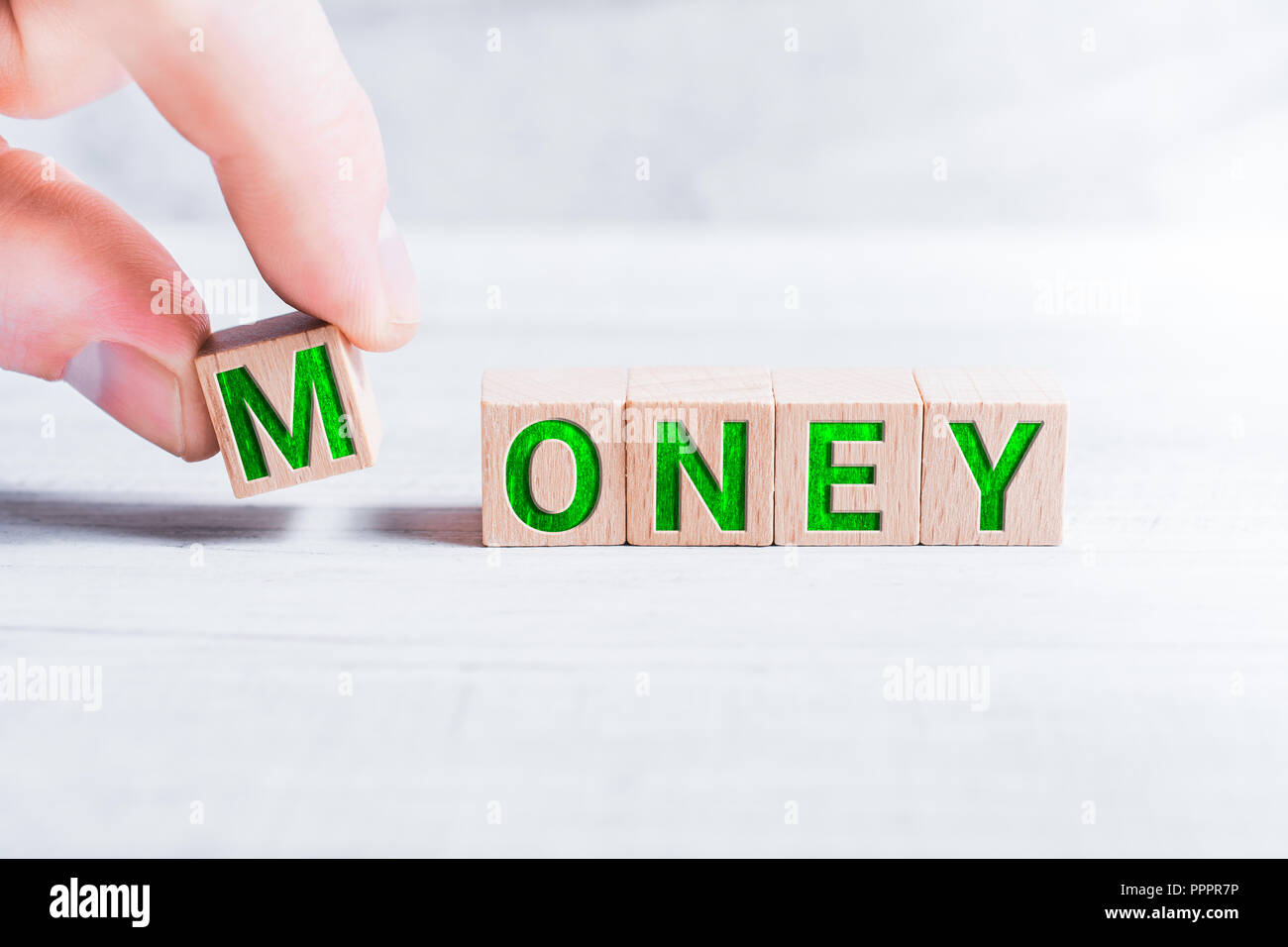 The Word Money Formed By Wooden Blocks And Arranged By Male Fingers On ...