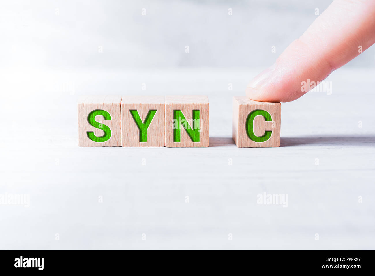 The Word Sync Formed By Wooden Blocks And Arranged By A Male Finger On ...