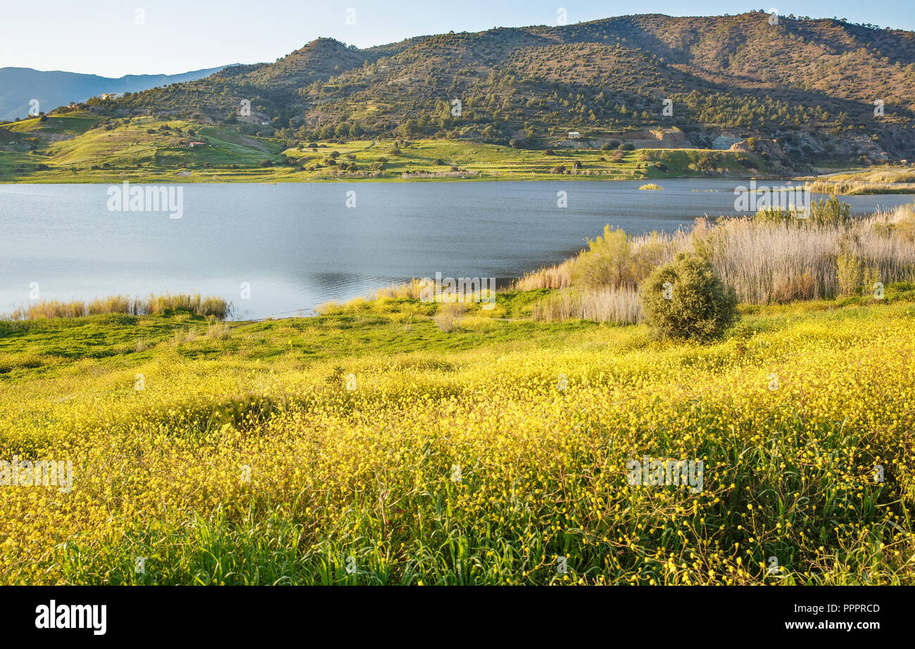 Cyprus landscape with mountains, lake and village Stock Photo - Alamy