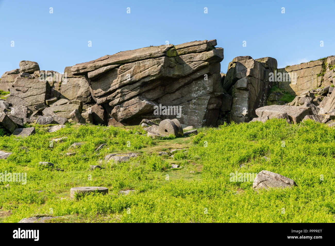 A millstone at Stanage Edge near Hathersage in the East Midlands, Peak ...
