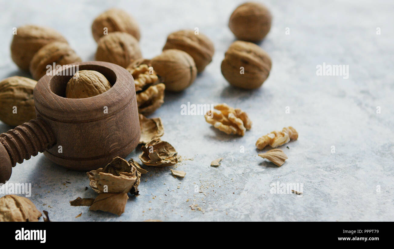 Walnuts in shells and cracker Stock Photo - Alamy
