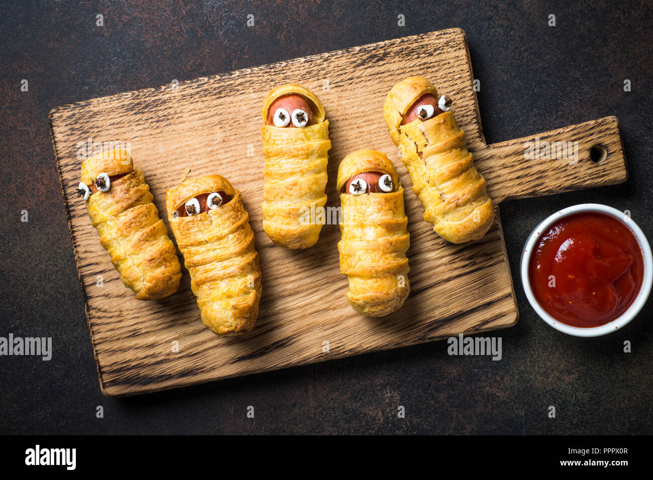 Halloween food. Scary sausage mummies in dough Stock Photo - Alamy