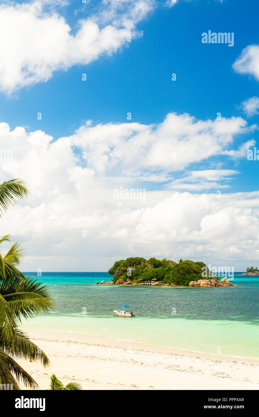Small lonely island near Praslin island, Seychelles. Vertical ...