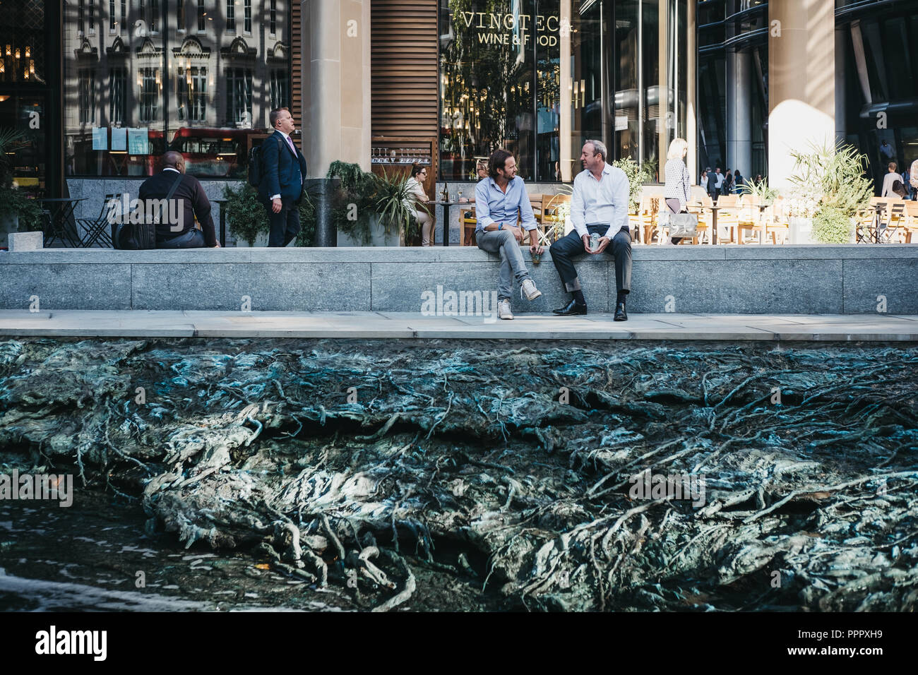 London, UK - September 17, 2018: Two men sitting, relaxing near ...