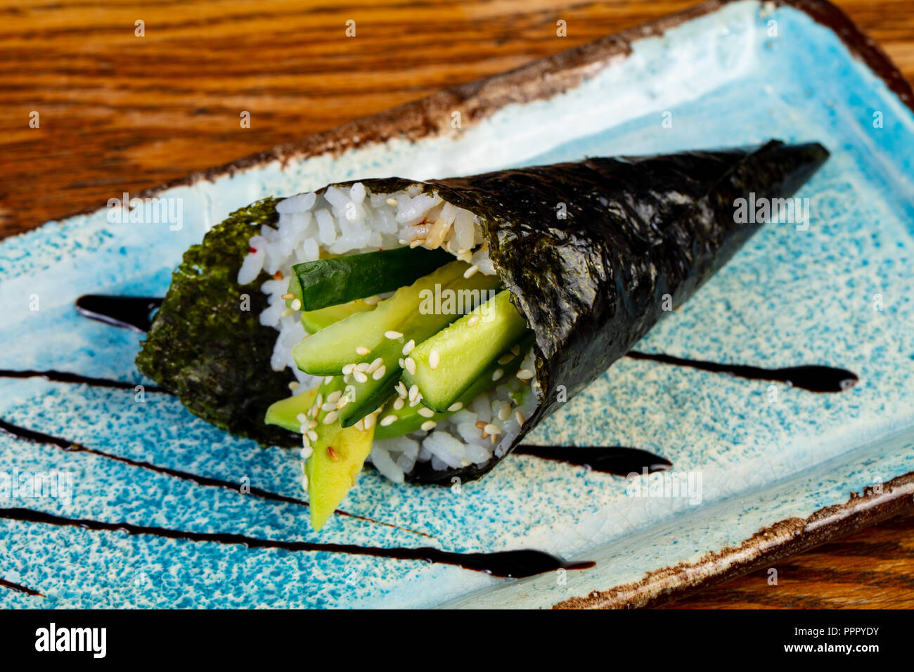 Japanese handroll temaki with fish and rice Stock Photo - Alamy