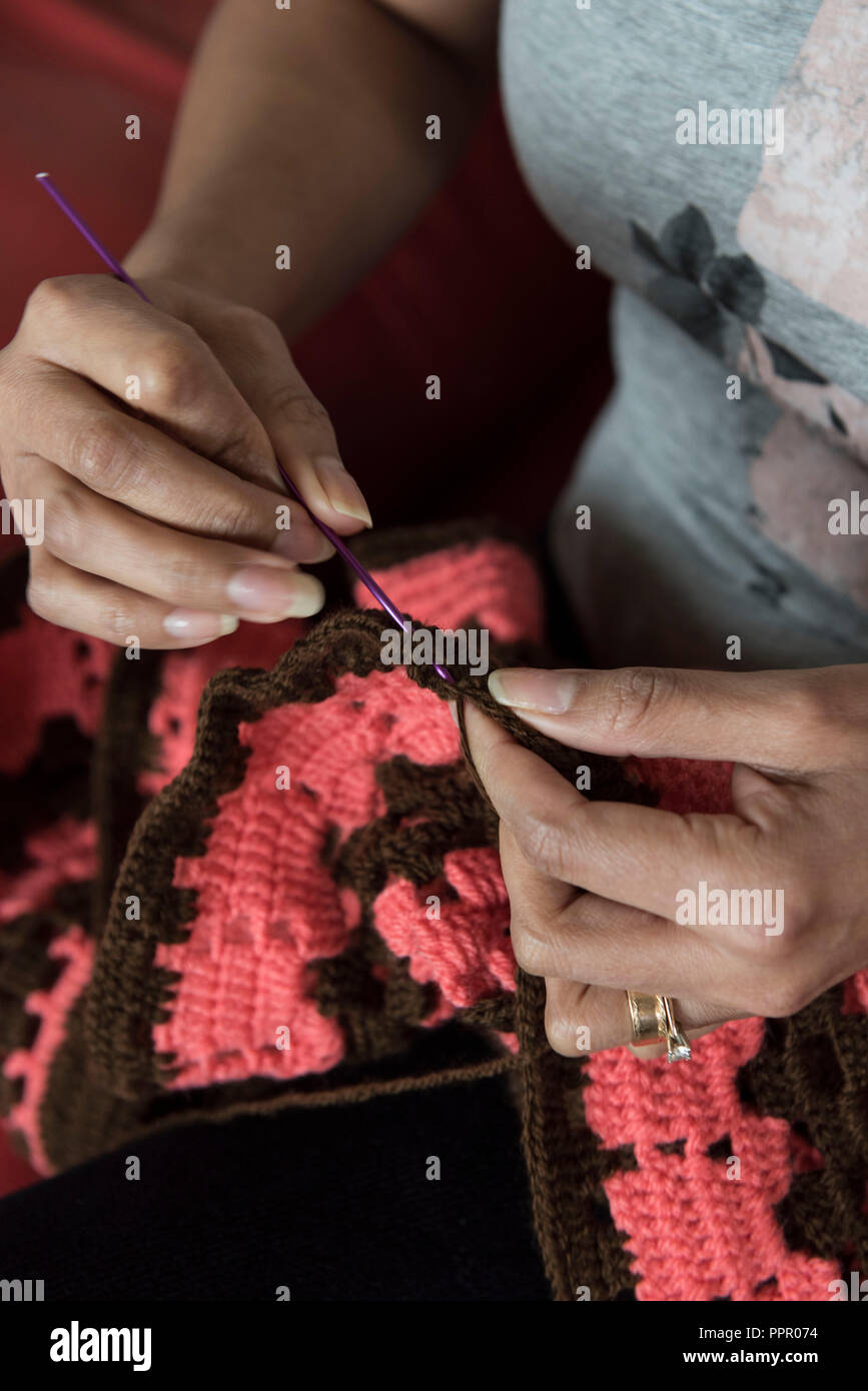 Close up of woman's hands crocheting a blanket Stock Photo - Alamy