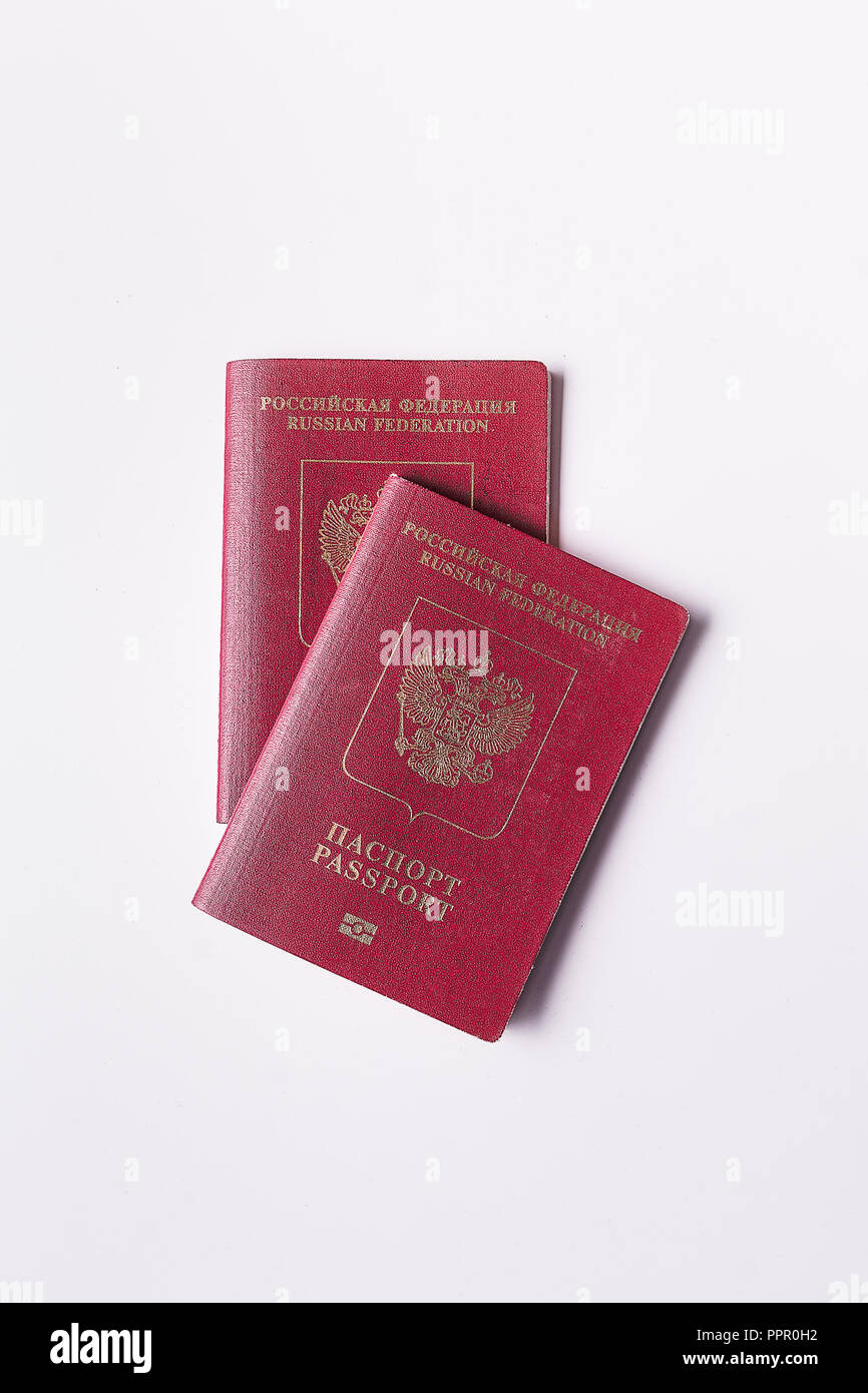 Vertical view of two russian passports against white background, copy ...