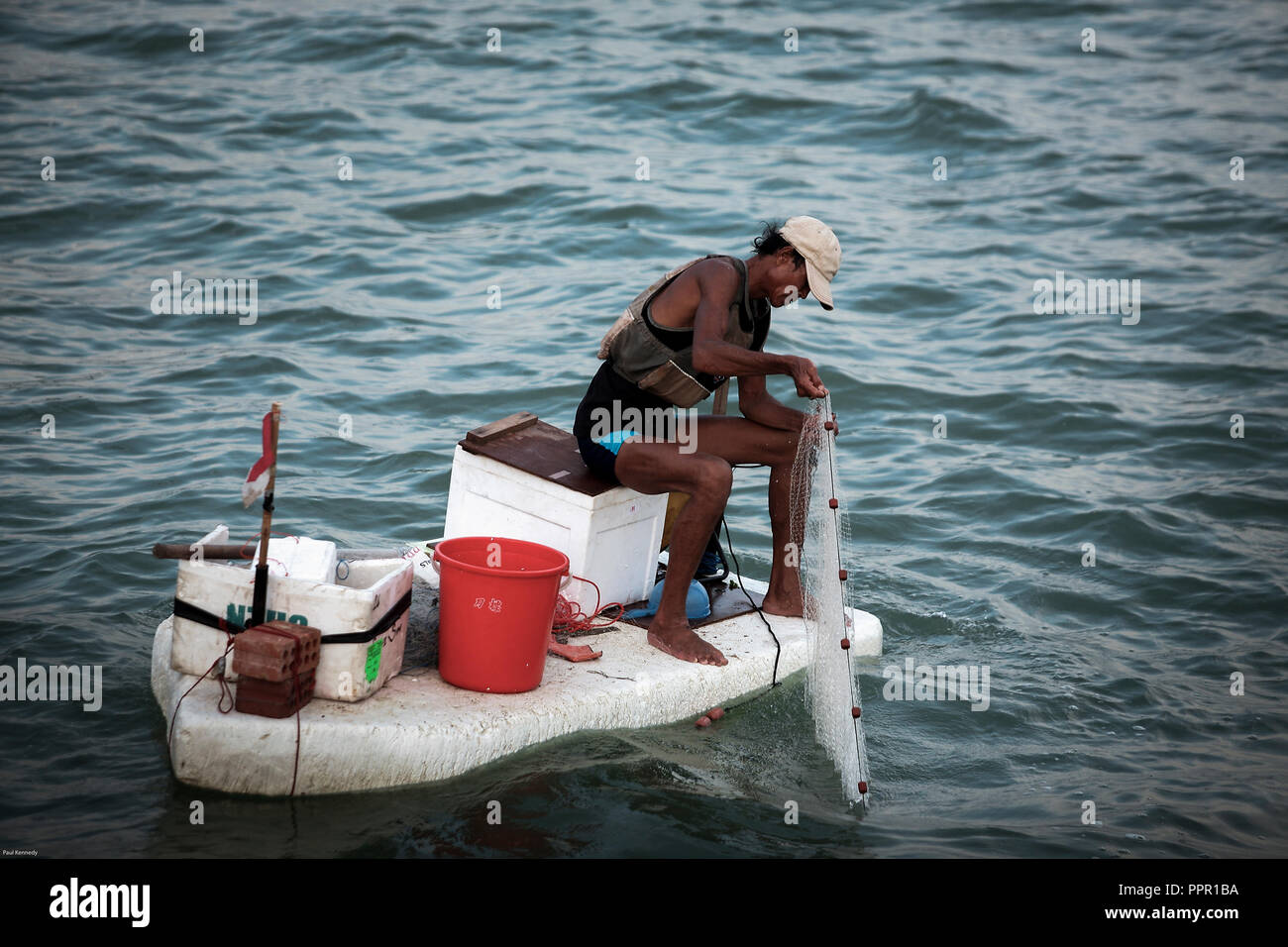 Man fishing from polystyrene boat in Singapore, Southeast Asia Stock ...