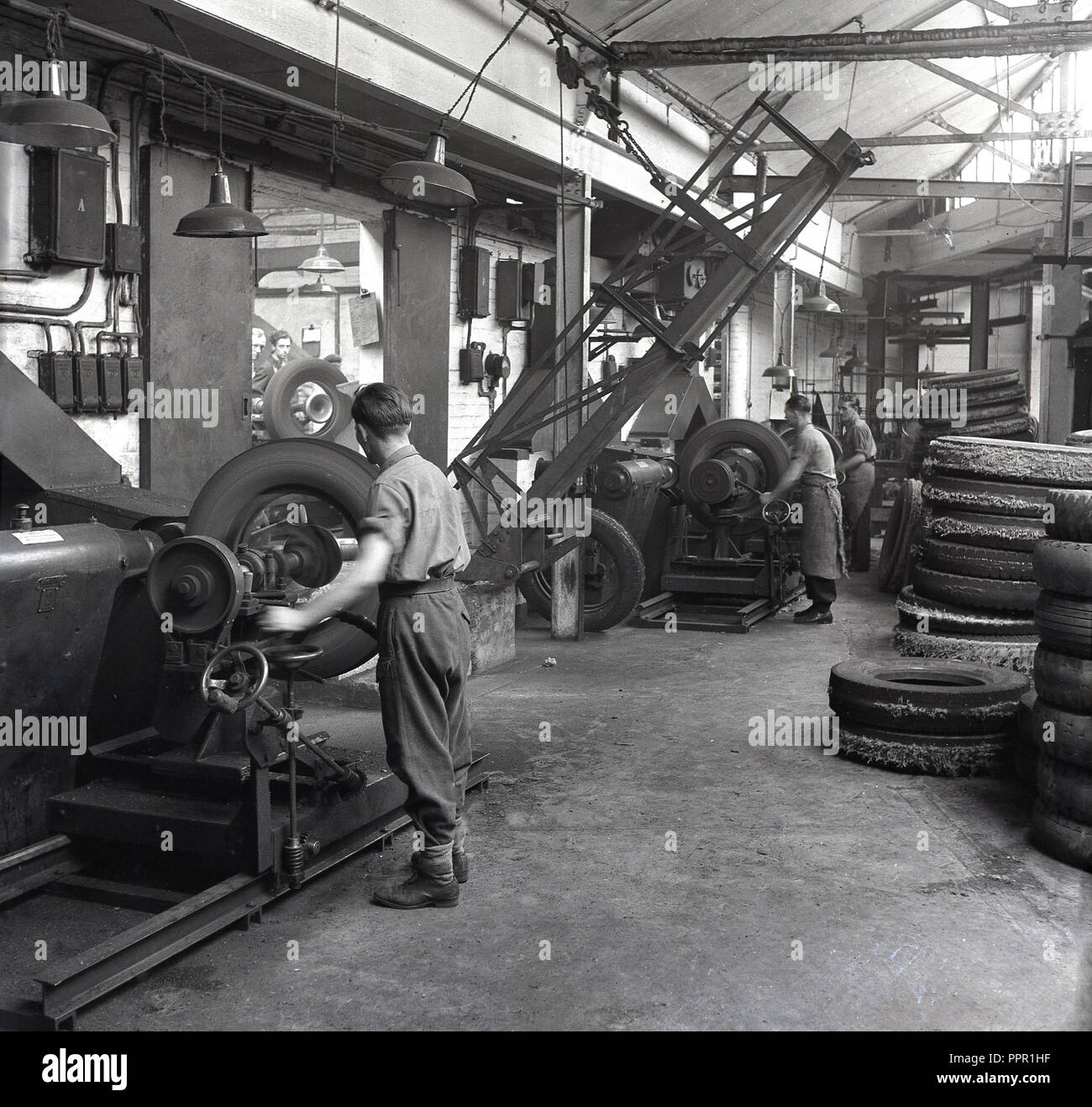 1950s, historical, male workers inside a tyre factory, England, UK. A ...