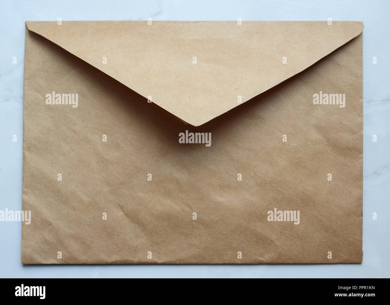 an empty golden envelope on the table Stock Photo - Alamy