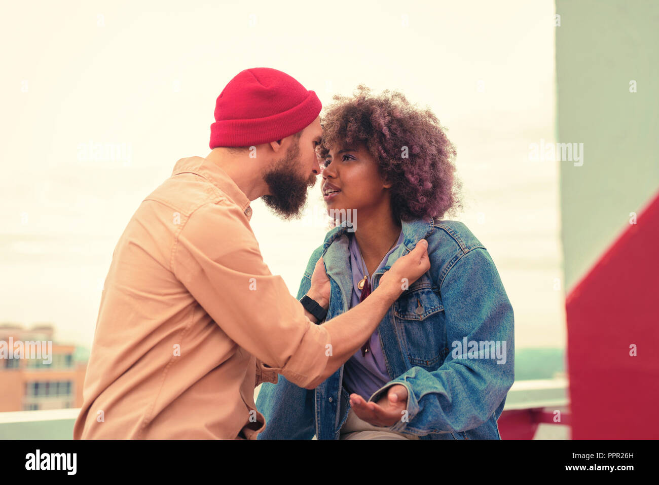 Angry man grabbing the jacket of his girlfriend and shouting at her ...