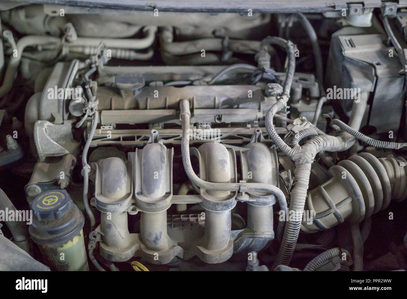 Dusty car engine parts with different tubes. Close up Stock Photo - Alamy