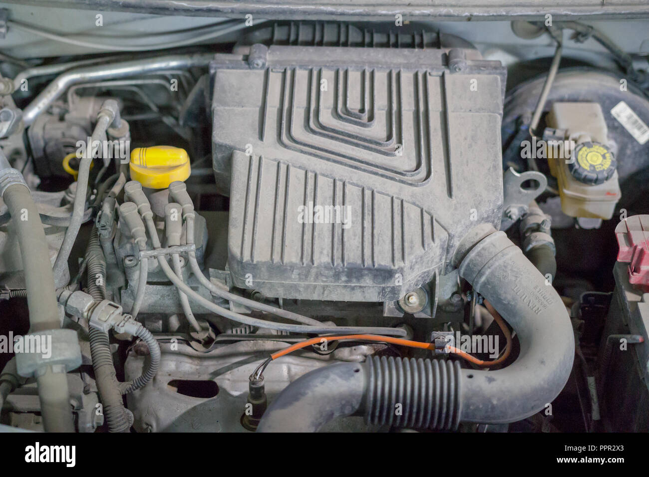 Dusty car engine parts with different tubes Stock Photo - Alamy