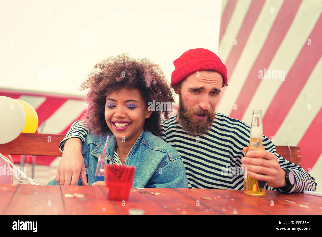 Two young people feeling silly after having all night party on the roof ...
