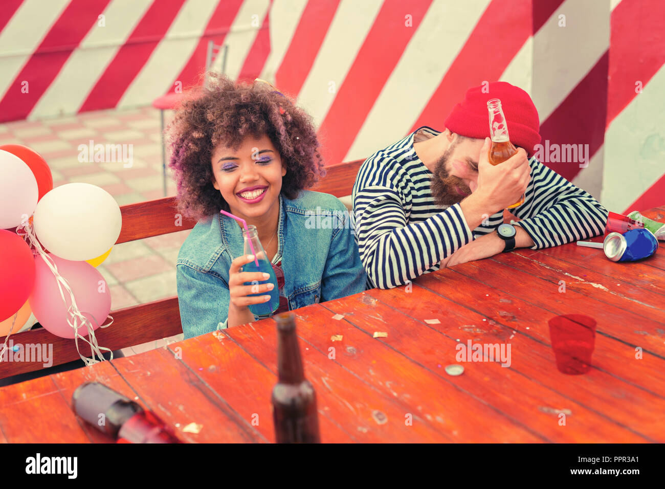 Positive couple laughing while feeling unwell after the party Stock ...
