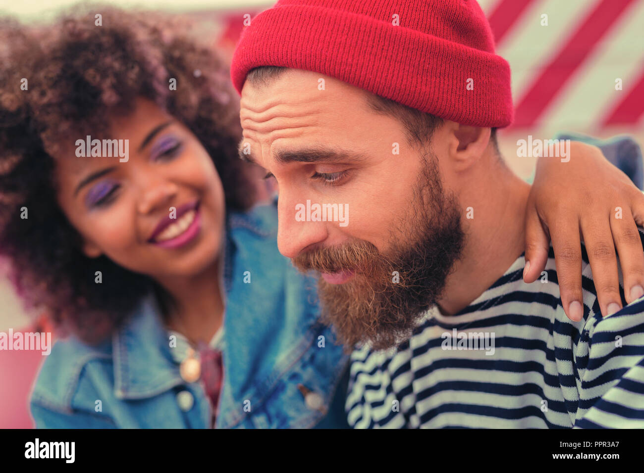 Young girl smiling to her boyfriend and encouraging him after party ...