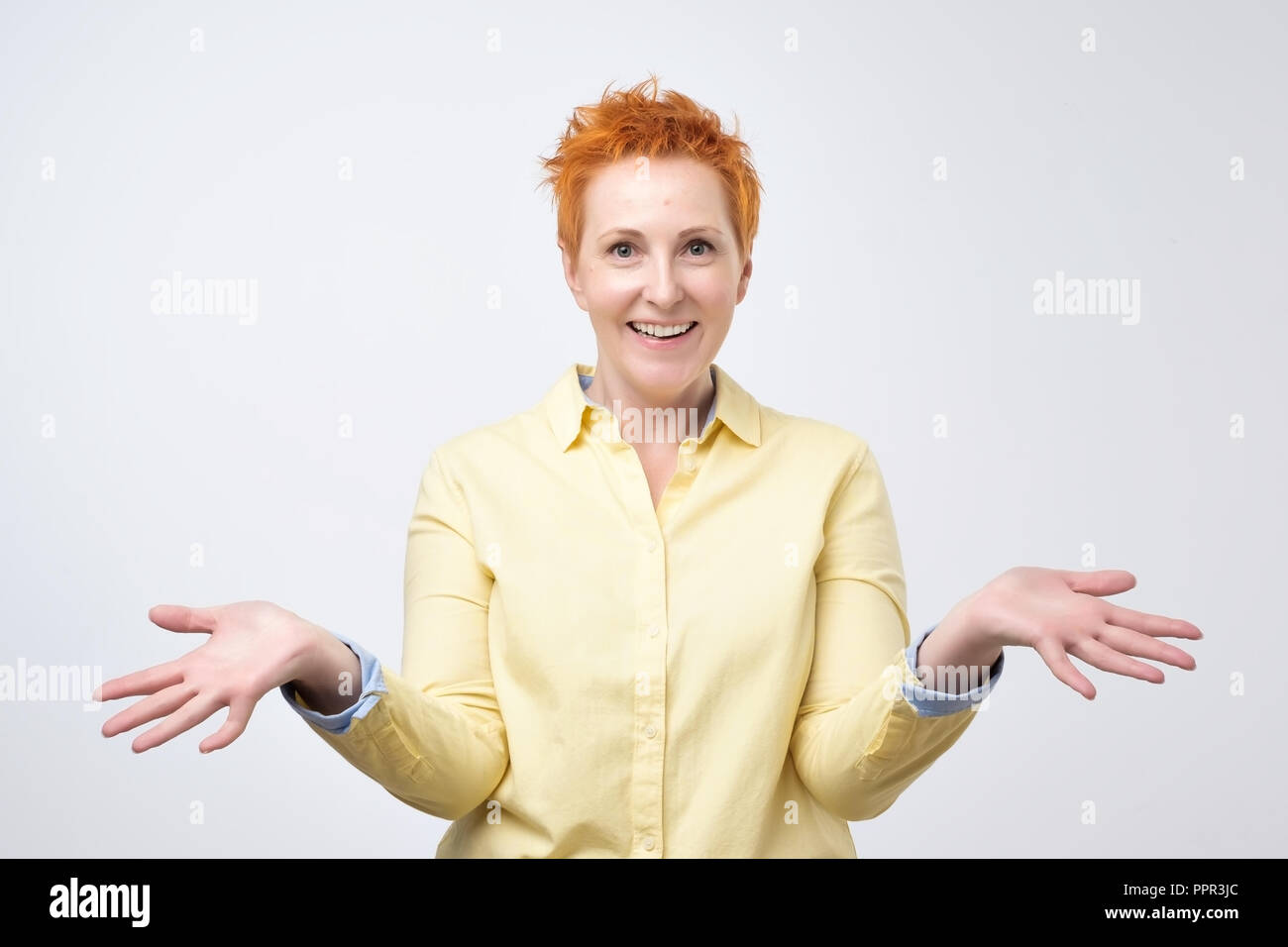 Beautiful woman present something with her arms wide open Stock Photo ...