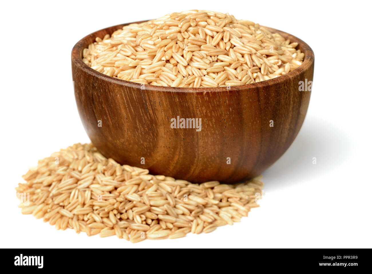 uncooked oats in the wooden bowl, isolated on white background Stock ...