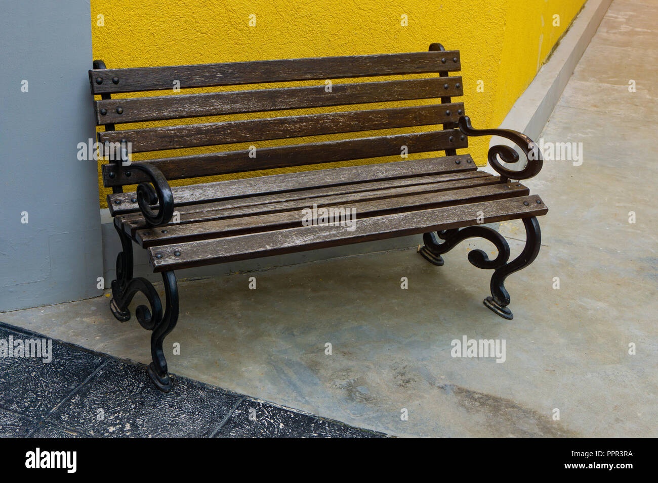 long wooden chair on yellow background Stock Photo - Alamy