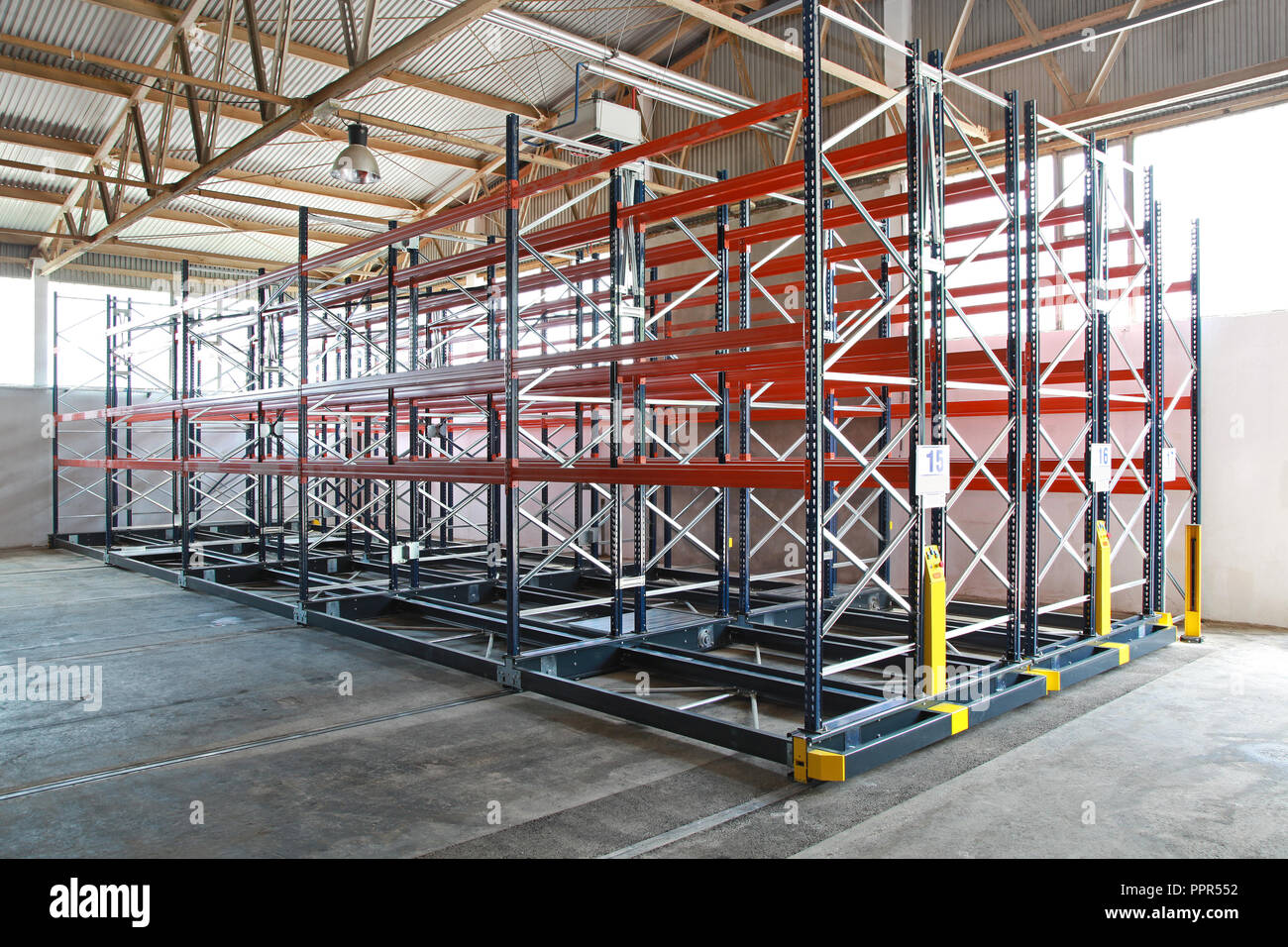 Mobile roller racking system in distribution warehouse Stock Photo - Alamy