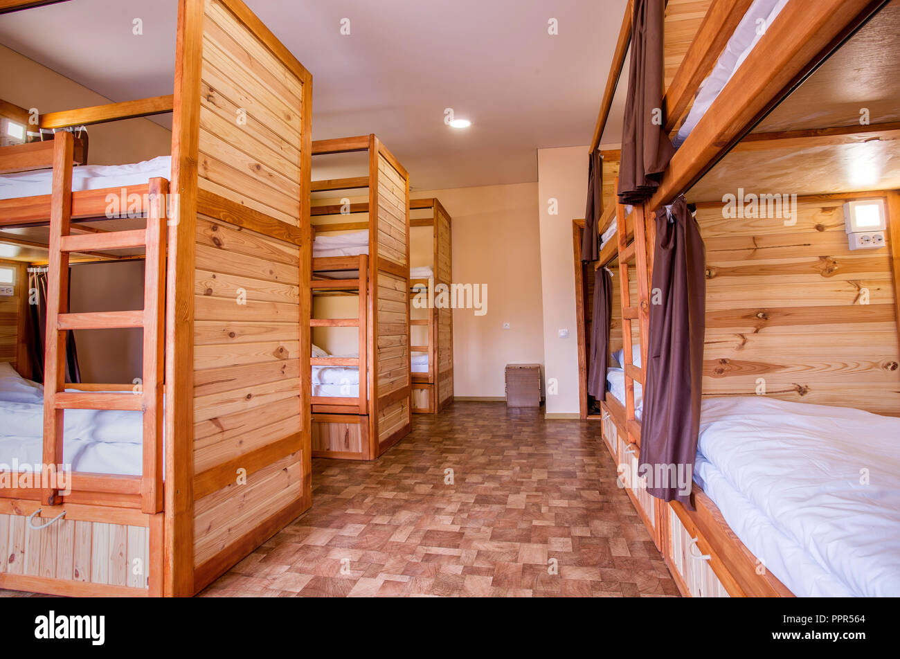 Personal lighting over each bed. Bunk wooden beds in the hostel. Five ...