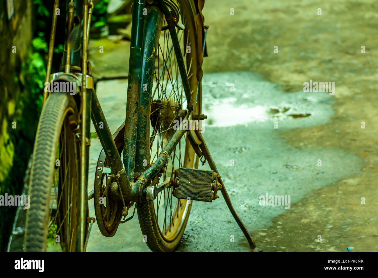 Old rusty vintage bicycle parked near road on a rural nature close up ...