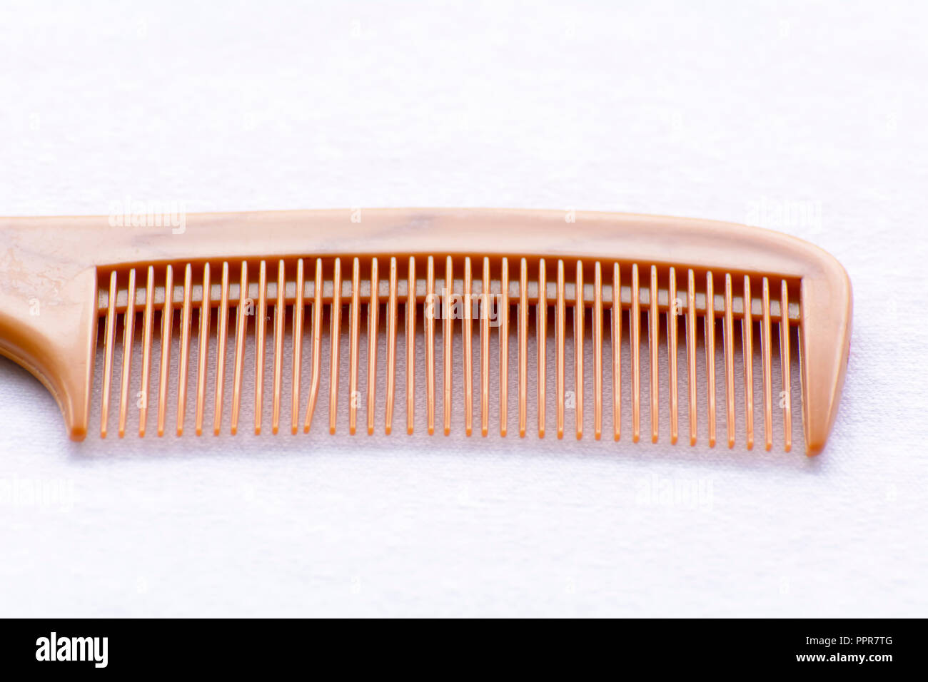 The brown hair comb on white background Stock Photo - Alamy