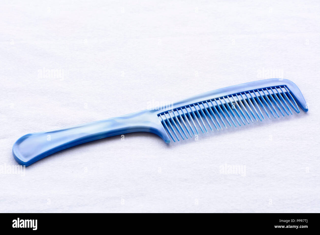 The blue hair comb on white background Stock Photo - Alamy