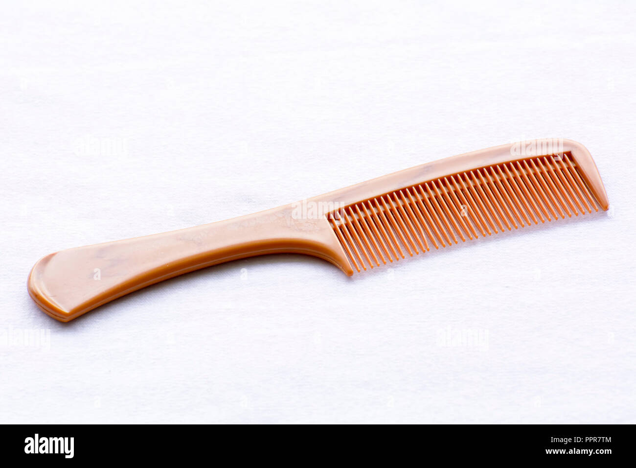 The brown hair comb on white background Stock Photo - Alamy