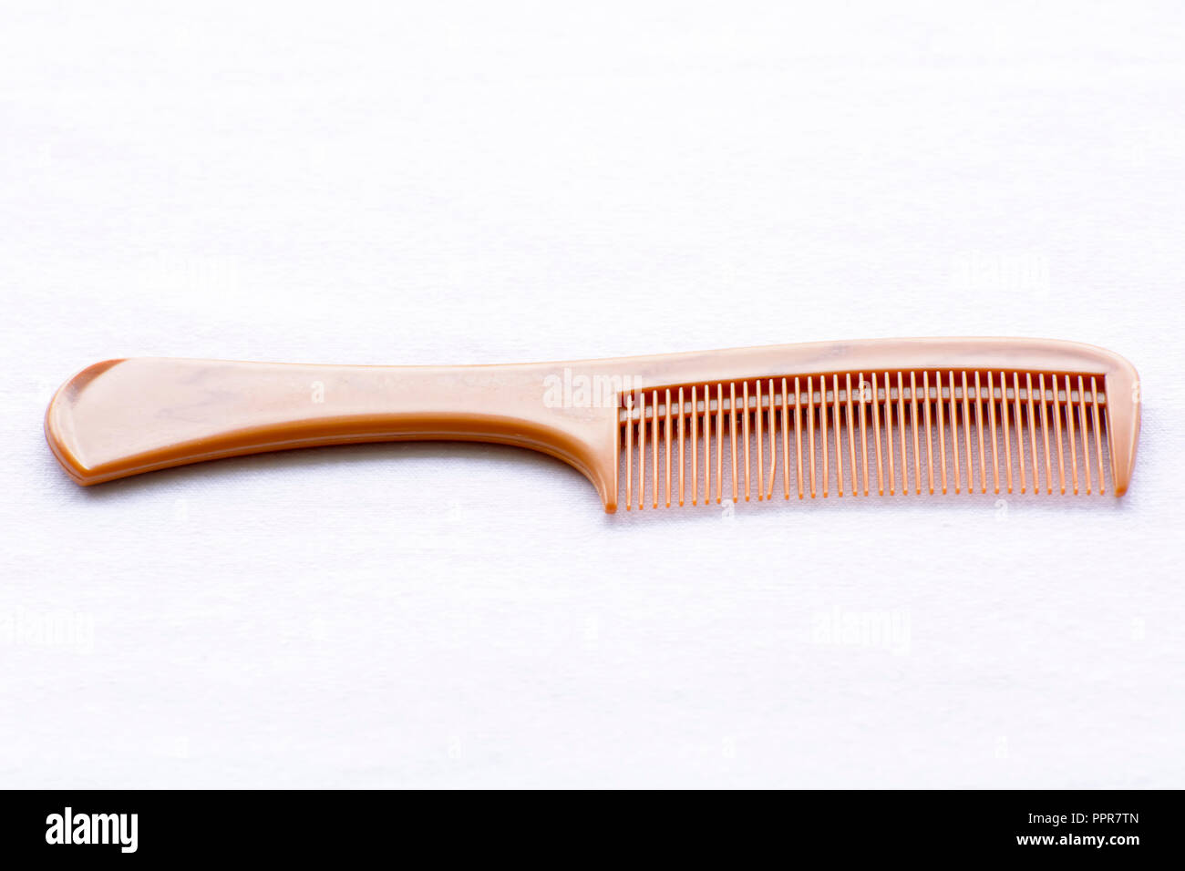 The brown hair comb on white background Stock Photo - Alamy
