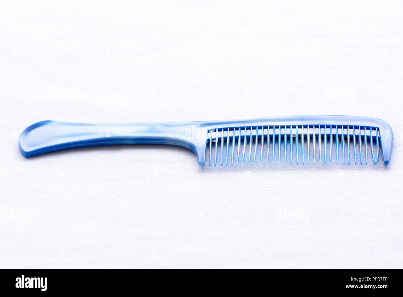 The blue hair comb on white background Stock Photo - Alamy