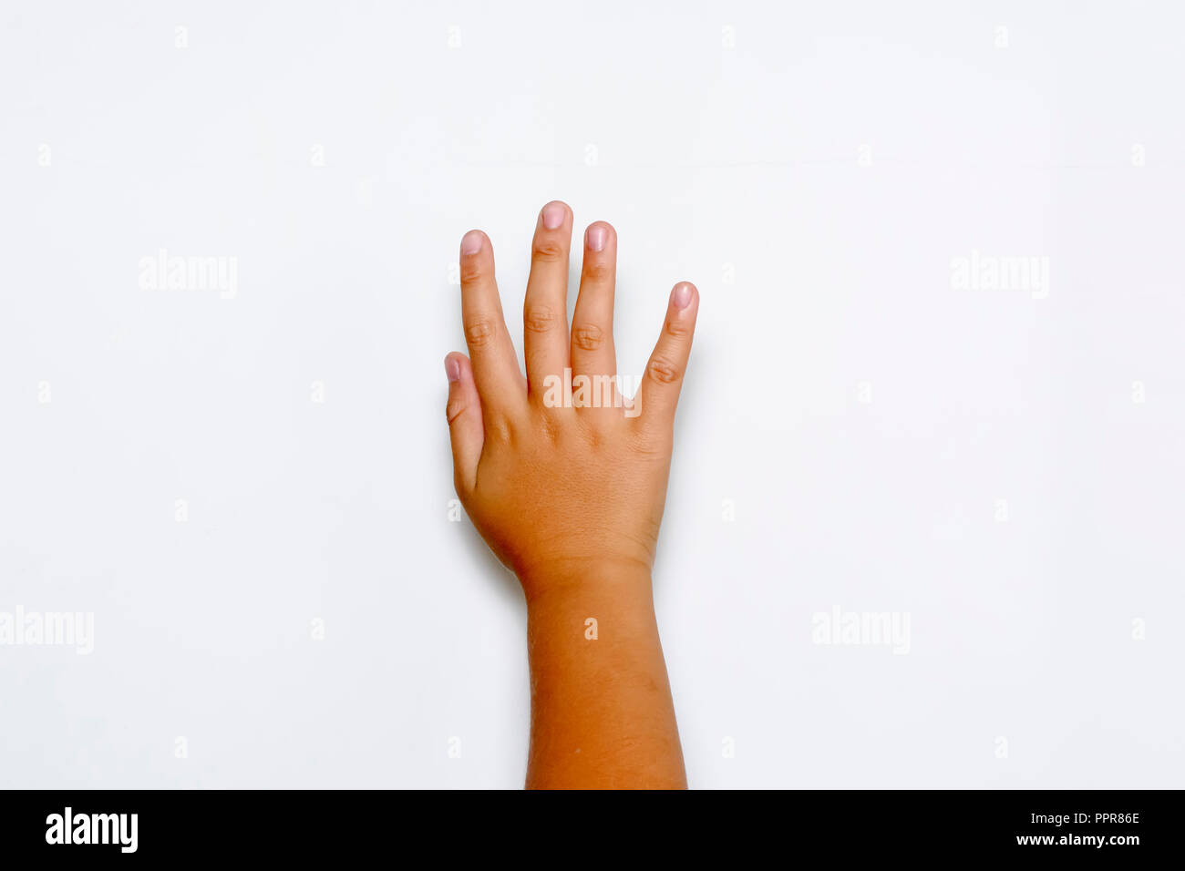 Boy raising five fingers up on hand on white background Stock Photo - Alamy