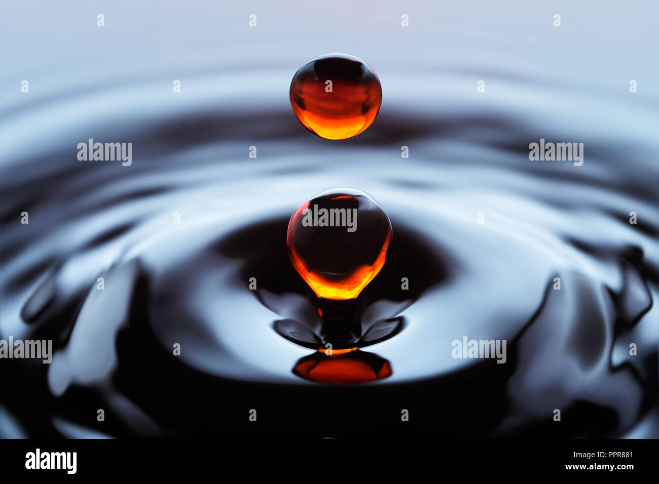 Splash. Round red drops falling on smooth surface of water Stock Photo ...