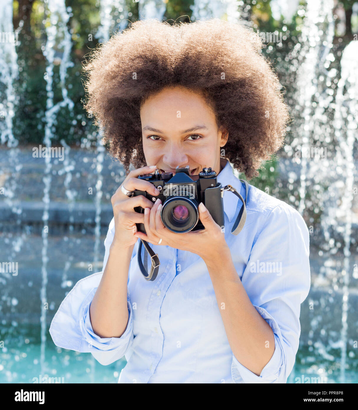 Portrait of charming black woman with retro camera, female photographer ...