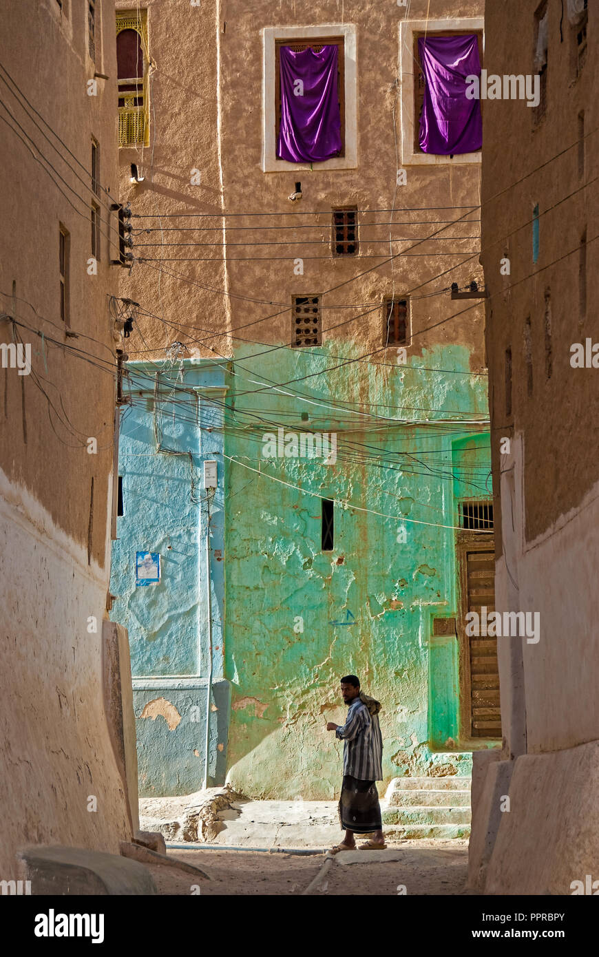 A young man in traditional clothes walks in the narrow streets on May 8 ...
