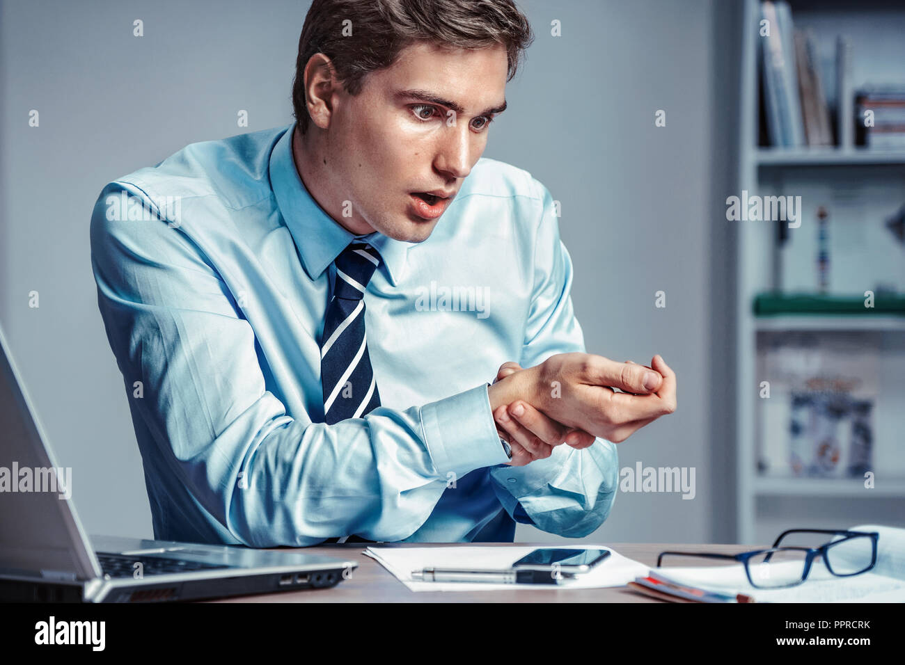 Worker checking his heart rate pulse. Photo of man working in the ...