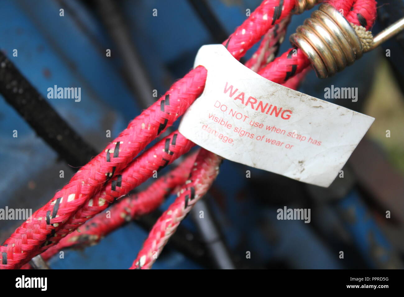 Frayed bungee straps with a label saying not to use when damaged Stock ...