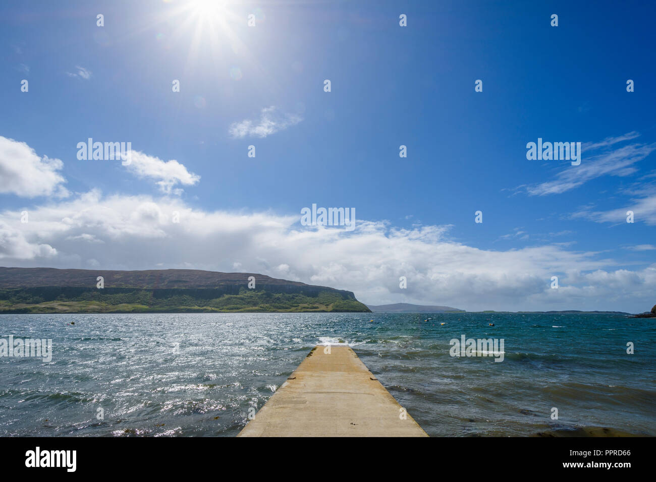 Concrete pier on sea with sun, Isle of Skye, Scotland, United Kingdom ...
